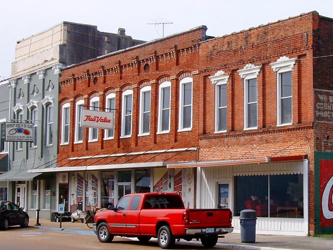 Sunlight plays across Water Valley's historic storefronts, highlighting architectural details from a more ornate era.