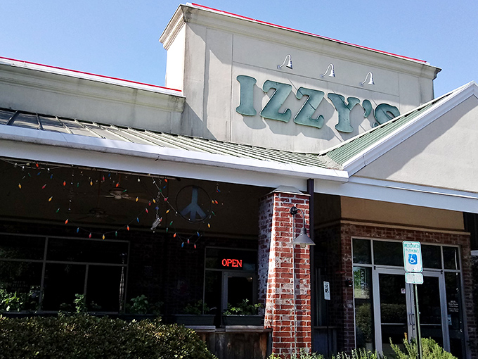 Izzy's welcomes hungry travelers with its distinctive green-trimmed roof and promise of brick oven delights&mdash;like finding a culinary oasis in Little Rock.