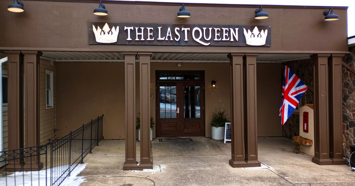 The Last Queen stands proudly in Enon, its stone facade and British flag promising an authentic pub experience that feels worlds away from Ohio cornfields.