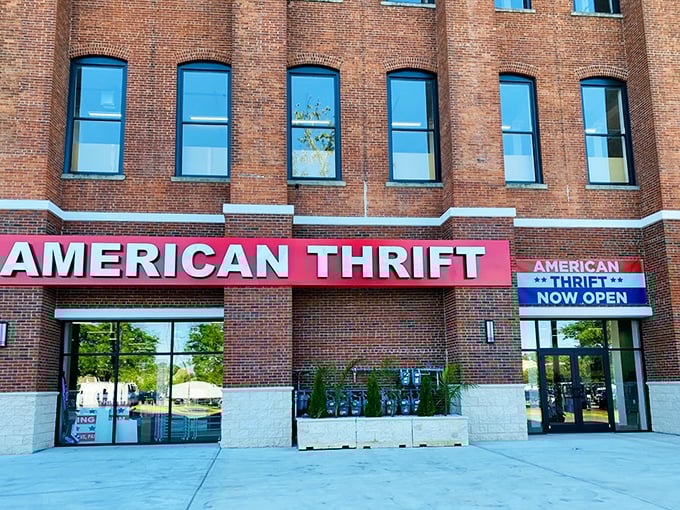 The brick facade of American Thrift Store stands like a temple to secondhand treasures, its bold red sign beckoning bargain hunters and nostalgia seekers alike.