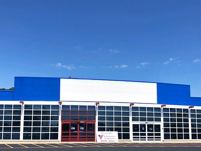The blue and white exterior stands like a retail fortress of possibility, promising treasure hunts behind those bold red doors.