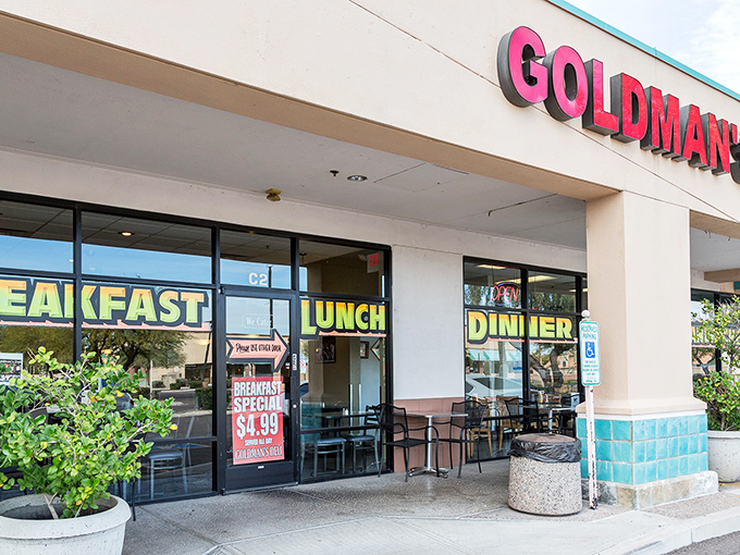 Welcome to sandwich paradise! Goldman's Deli stands proud, its neon sign a beacon for hungry souls seeking deli nirvana. 