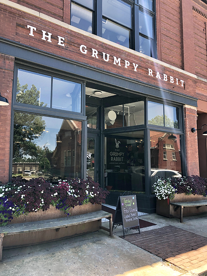 The historic brick facade of The Grumpy Rabbit stands proudly on Lonoke's main street, its vintage charm belying the culinary adventure waiting inside.