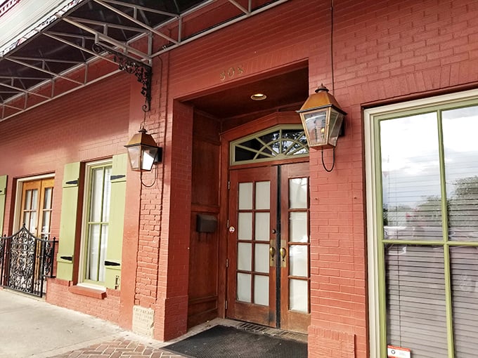 The brick-red exterior of Mike's Place stands as Conway's culinary beacon, its green shutters and vintage sign promising delicious adventures within.