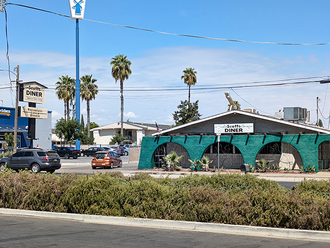 The turquoise exterior of Scotts Diner stands out like a culinary oasis in Merced, beckoning hungry travelers with its charming retro vibe.