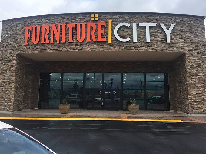 The grand entrance to Furniture City beckons with its impressive stone facade and bold signage&mdash;like the pearly gates of home decor heaven.