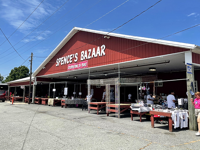 The iconic red barn of Spence's Bazaar stands like a treasure chest waiting to be opened, promising adventures in bargain hunting under the Delaware sky.