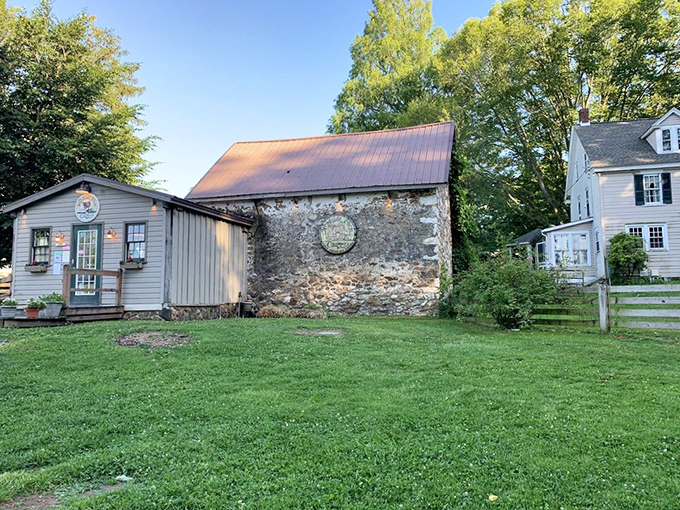 The farmhouse charm of Woodside Farm Creamery beckons like an ice cream siren, with its stone wall and iconic cone sign promising dairy delights within.