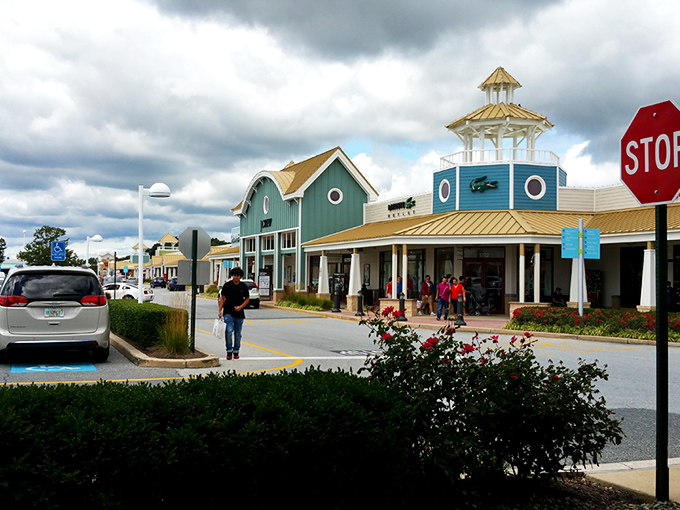 The iconic lighthouse-topped GUESS storefront welcomes shoppers like a beacon of bargains. Coastal charm meets retail therapy in this architectural gem.