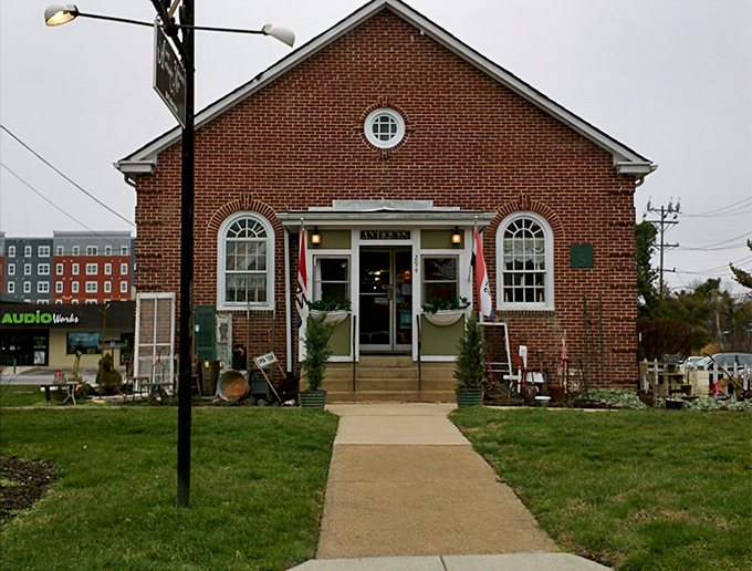 The charming brick exterior of Aunt Margaret's beckons with its round window and vintage lanterns—like a time portal disguised as a building.