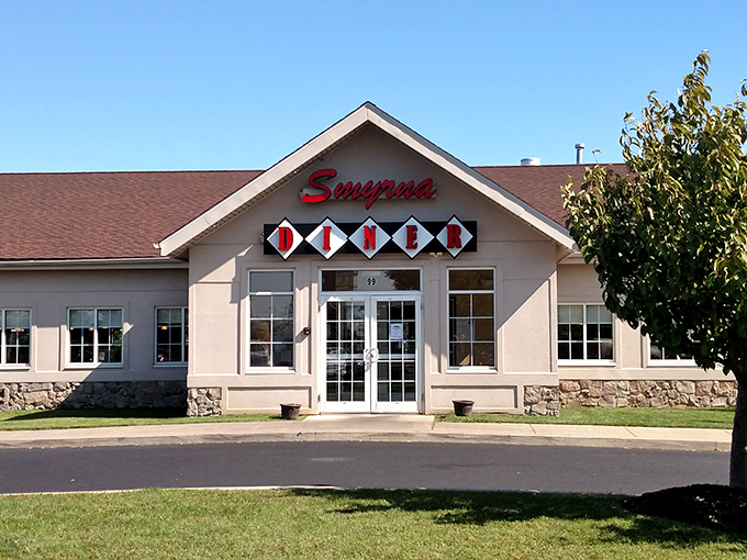 The iconic red Smyrna Diner sign welcomes hungry travelers like a culinary lighthouse guiding you to comfort food harbor.