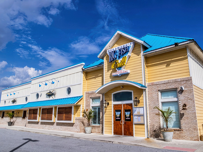 The cheerful yellow exterior of Big Fish Grill stands like a beacon for seafood lovers, promising maritime delights within its nautical-themed walls.