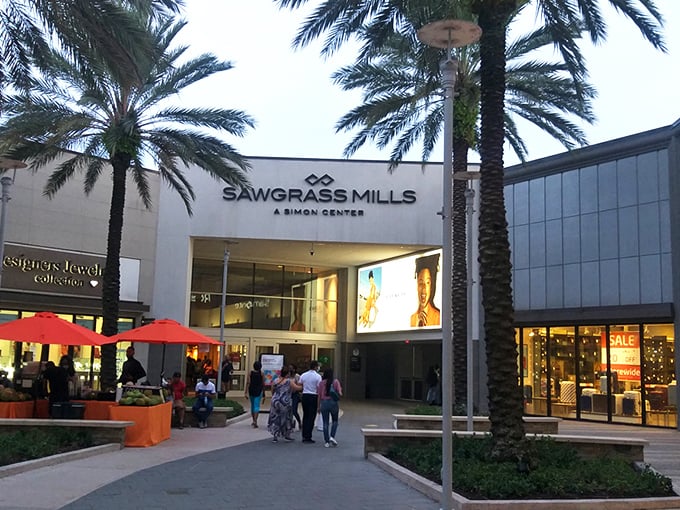 Palm trees frame the entrance to Sawgrass Mills like nature's own welcome committee. Florida shopping doesn't get more iconic than this retail oasis.