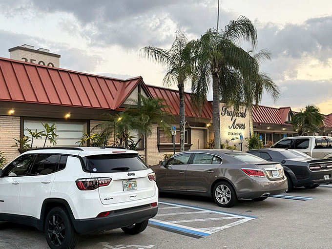 The iconic yellow brick facade of Tropical Acres Steakhouse stands as a time capsule of old Florida dining, palm trees standing guard like culinary sentinels.