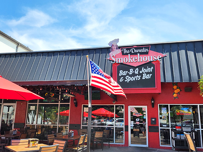 The Dunedin Smokehouse's vibrant exterior beckons like a barbecue siren, with its inviting patio where locals gather to worship at the altar of smoked meats.