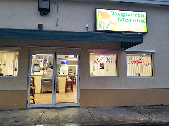 The unassuming exterior of Taqueria Morelia stands like a culinary speakeasy in Florida City, promising authentic flavors behind its modest fa&ccedil;ade.