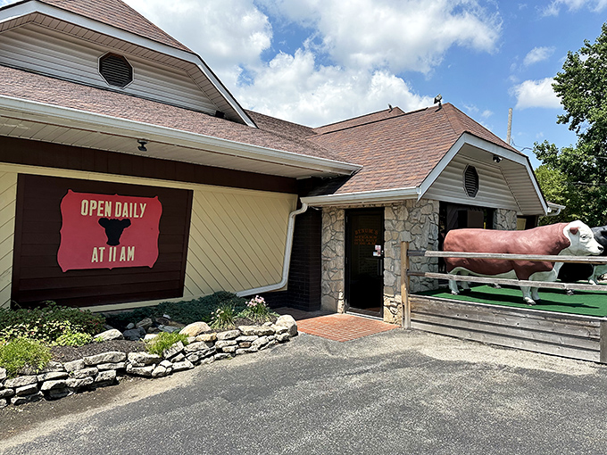 Those cow statues aren't just decoration—they're greeters, bouncers, and a promise of what awaits inside Bynum's rustic stone-and-wood exterior.
