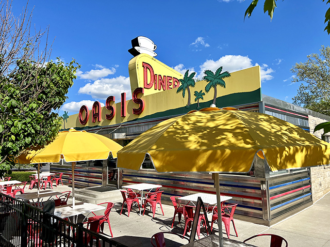The sunshine-yellow exterior of Oasis Diner beckons like a time portal to the 1950s, complete with palm trees that seem hilariously optimistic in Indiana weather.