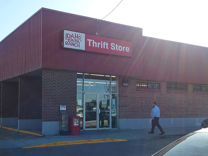 The iconic red exterior of Idaho Youth Ranch Thrift Store stands as a beacon of bargain-hunting possibilities in Meridian. 