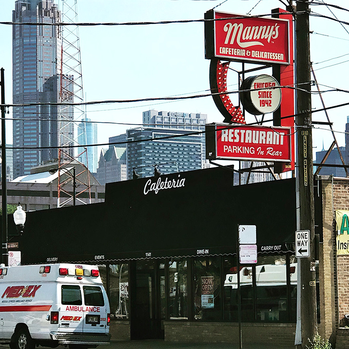 Manny's iconic red sign stands like a culinary lighthouse against Chicago's skyline, promising delicious refuge from the busy world outside.