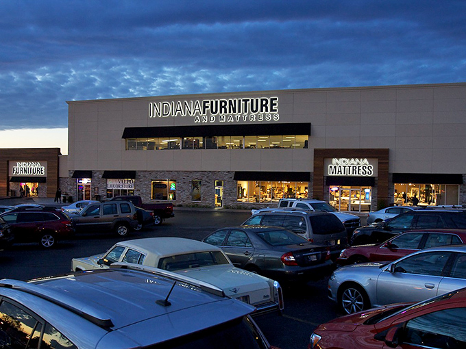 The modern exterior blends warm wood paneling with stone accents, creating a fa&ccedil;ade that says "Yes, I'm a furniture store, but I've got style."