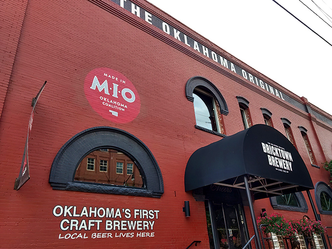 The iconic red brick exterior of Bricktown Brewery stands as a beacon of culinary promise in Oklahoma City's historic district, where industrial charm meets modern appetite.