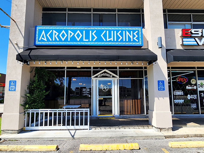 The bright blue sign of Acropolis Greek Cafe stands out like a Mediterranean beacon in Metairie, promising authentic Greek flavors just steps away.