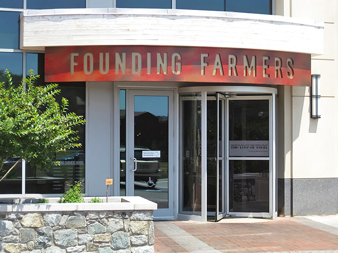 The unassuming entrance to flavor paradise. Founding Farmers' modest exterior in Potomac gives zero hints about the culinary fireworks waiting inside.