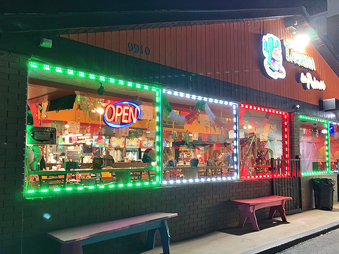 The neon-lit exterior of Taqueria Los Primos glows like a beacon of culinary promise in Laurel after dark. Mexican food paradise awaits!