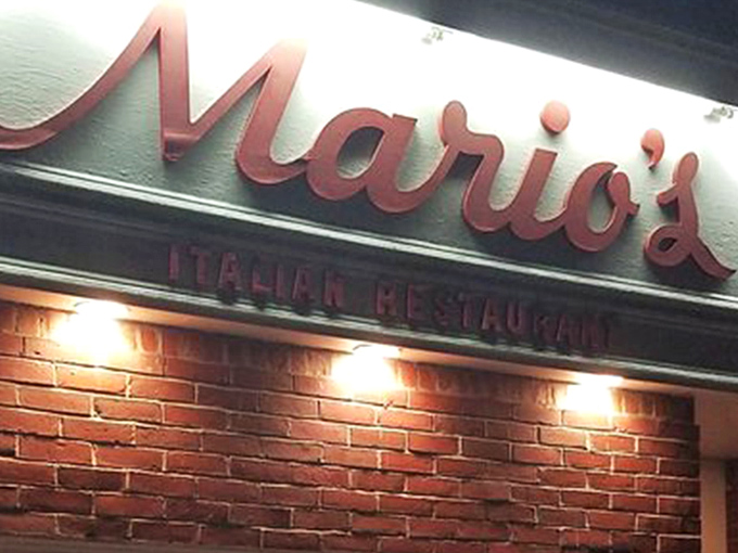 The iconic red script of Mario's against classic brick – like a neon welcome sign for your stomach that's been guiding hungry Lexingtonians for generations.