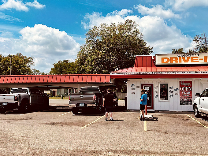 The iconic red-roofed Wagner's Drive-In stands like a time portal to simpler days, beckoning hungry travelers with promises of hand-crafted burgers and nostalgia by the plateful.