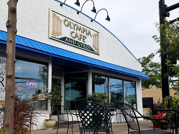 The blue-trimmed facade of Olympia Cafe beckons like a Mediterranean mirage in suburban Osseo, promising Greek delights and all-day breakfast adventures.