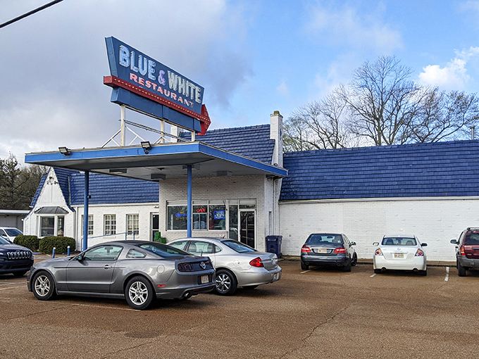 The iconic Blue & White sign beckons hungry travelers like a neon lighthouse on Highway 61. This classic roadside architecture promises comfort food and Mississippi hospitality.