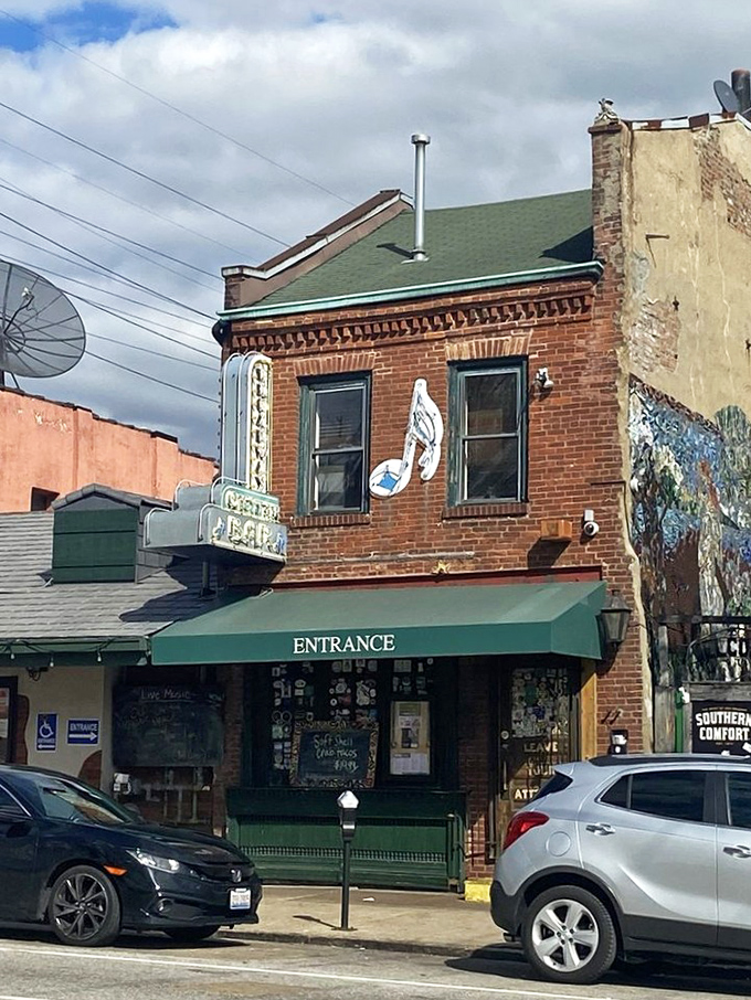 The historic brick facade of Broadway Oyster Bar welcomes seafood lovers with its vibrant green awning and door plastered with memories of good times past.