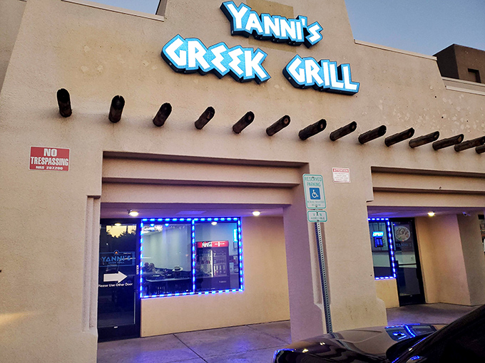 The unassuming exterior of Yanni's Greek Grill stands like a Mediterranean mirage in the Las Vegas desert, promising authentic flavors behind its blue signage.