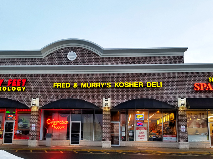The Promised Land of pastrami sits quietly in a strip mall, its yellow sign a beacon to hungry souls seeking deli salvation.