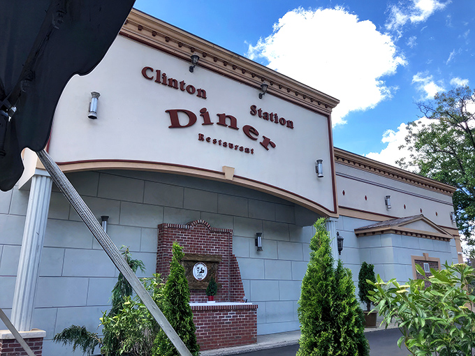 The Clinton Station Diner stands proudly against the New Jersey sky, its classic facade promising comfort food treasures within. No ordinary roadside stop, this is a destination.
