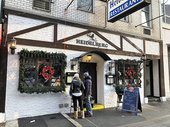 The storybook facade of Heidelberg Restaurant beckons with its warm yellow glow, promising Bavarian magic in the heart of Manhattan's concrete jungle.