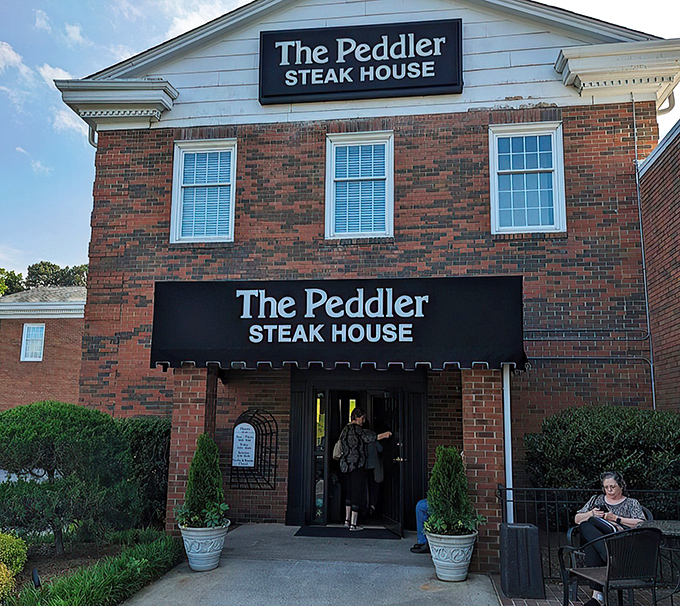 The brick fa&ccedil;ade of The Peddler stands like a carnivore's lighthouse, beckoning hungry travelers with its classic steakhouse promise. Some buildings just look delicious.