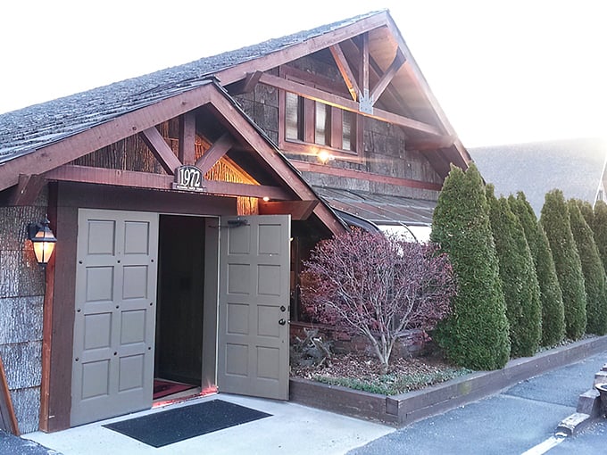 The rustic cabin exterior with its weathered shingles and iconic 1972 entrance doesn't just whisper "come in" – it practically shouts "carnivorous nirvana awaits!"