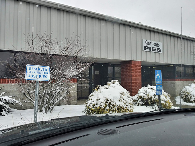 The unassuming exterior of Just Pies belies the magic happening inside. Like finding a treasure chest disguised as a storage shed.