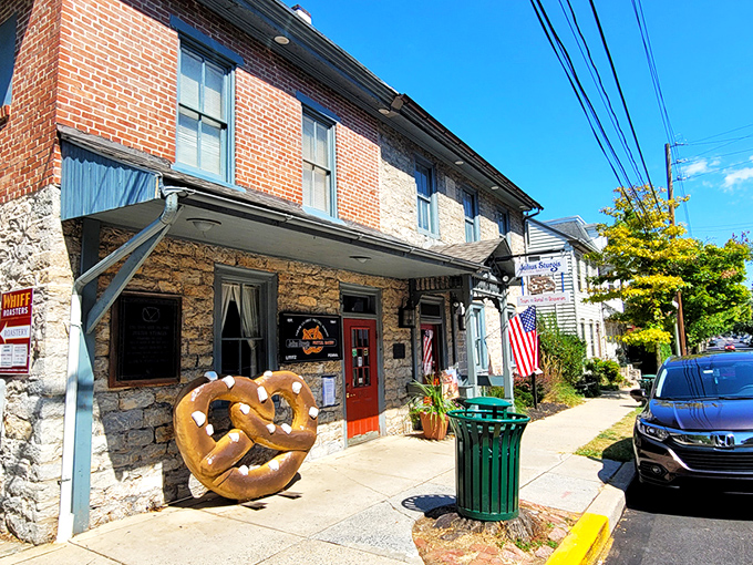 A stone and brick facade with bright blue trim and welcoming red doors &ndash; Julius Sturgis stands as a beacon of pretzel perfection in charming Lititz.