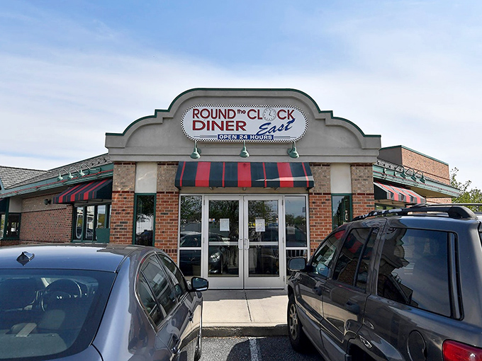 The classic brick exterior with its red and green awning stands like a beacon to hungry travelers. Diner paradise awaits 24/7! 