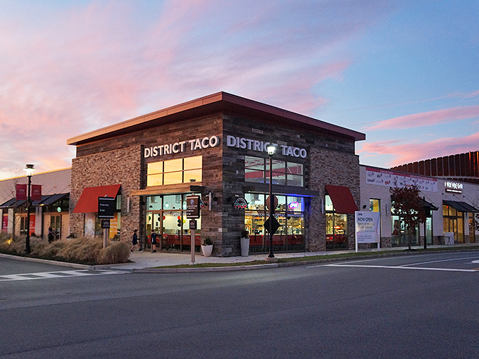 The rustic wooden exterior of District Taco welcomes hungry visitors with its vibrant sign and colorful flower boxes&mdash;a taco oasis in King of Prussia.