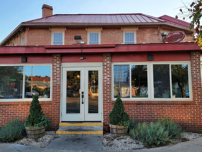 The historic brick exterior of Old Canal Smoke House welcomes you with its charming red awning and flower boxes&mdash;like a barbecue beacon calling you home.