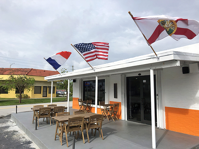 Amy's charming exterior welcomes you with a splash of European flair. Those red awnings and potted flowers aren't just decoration&mdash;they're a promise of the warmth waiting inside.
