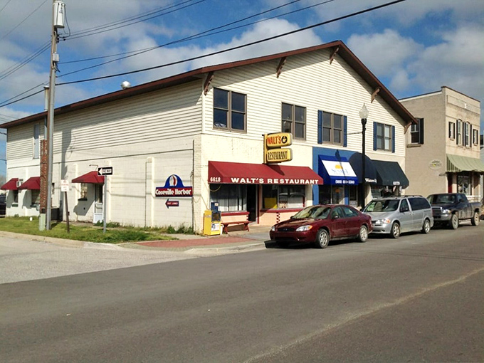 The unassuming yellow brick exterior of Walt's Restaurant stands as a beacon of breakfast hope on Caseville's main street, promising comfort food and local charm.