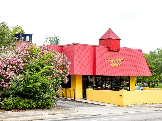 The bright yellow building with its iconic red roof stands like a barbecue beacon in downtown Jacksonville, drawing hungry pilgrims since 1957.