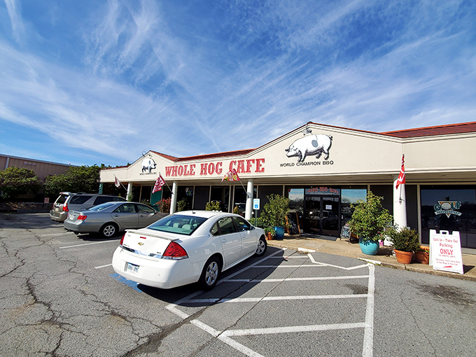 The promise of BBQ bliss beckons from this unassuming storefront. Whole Hog's iconic red sign stands like a carnivore's North Star against Arkansas skies.