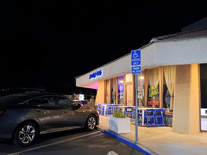 The blue glow of Athena Gyro's sign beckons like a Mediterranean lighthouse in the desert night, promising authentic Greek flavors behind those welcoming doors.